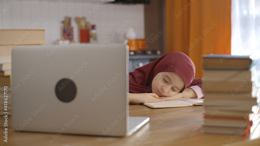Little girl in a turban tired of being at home and learning from ...