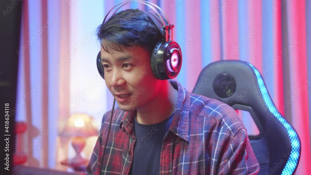 Young Asian Man Gamer Playing Game And Celebrates Victory Stock ビデオ ...