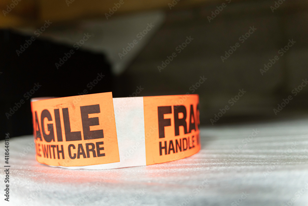 Orange colored shipping label for delivering fragile items Stock Photo ...
