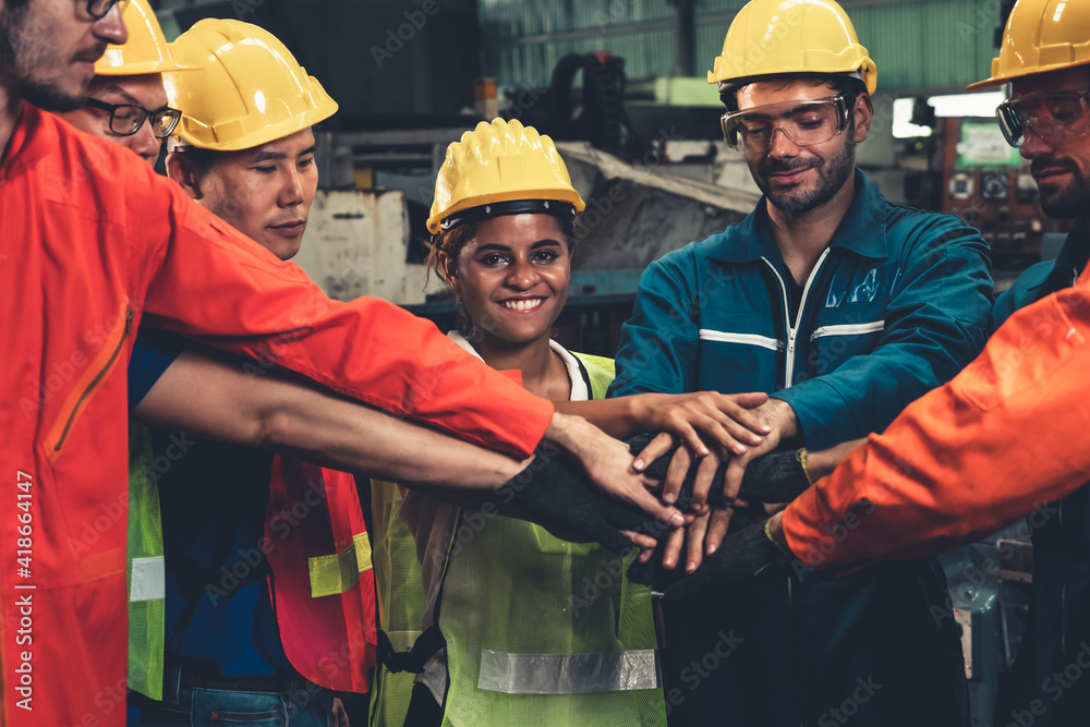 Skillful worker stand together showing teamwork in the factory ...