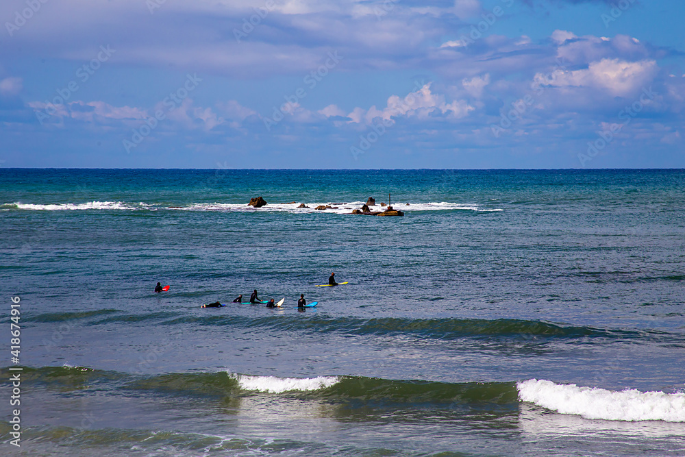 Tel Aviv, Israel - March 04, 2021: People surfing, surfers swimming in ...