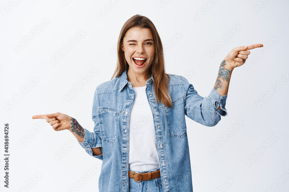 Smiling beautiful woman pointing sideways, showing two choices ...