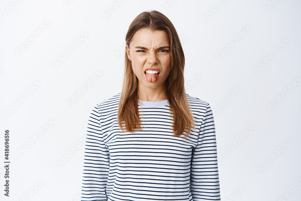 Portrait of disgusted young woman express dislike and disdain, showing ...