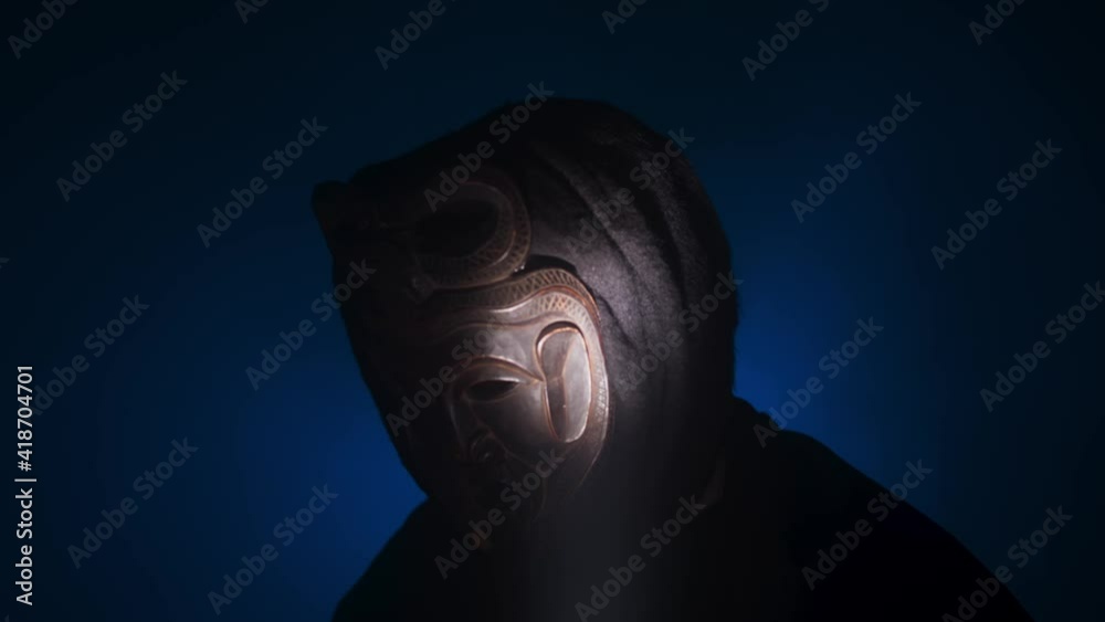 Close up of a scary face, mysterious man in mask, looking at the camera ...