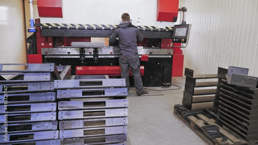 bending of sheet metal. A bending machine operator places and bens ...