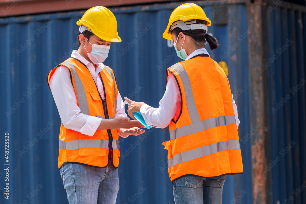 Factory workers wear face mask and safety dress cleaning hand with ...