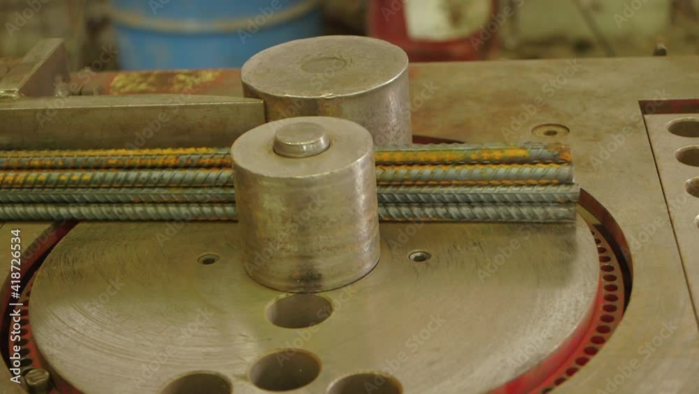 4 rods of rebar a placed into a rebar bender and bent to a 90 degree ...