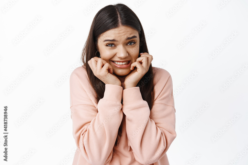 Awkward young woman feel uncomfortable, squeeze teeth and looking ...