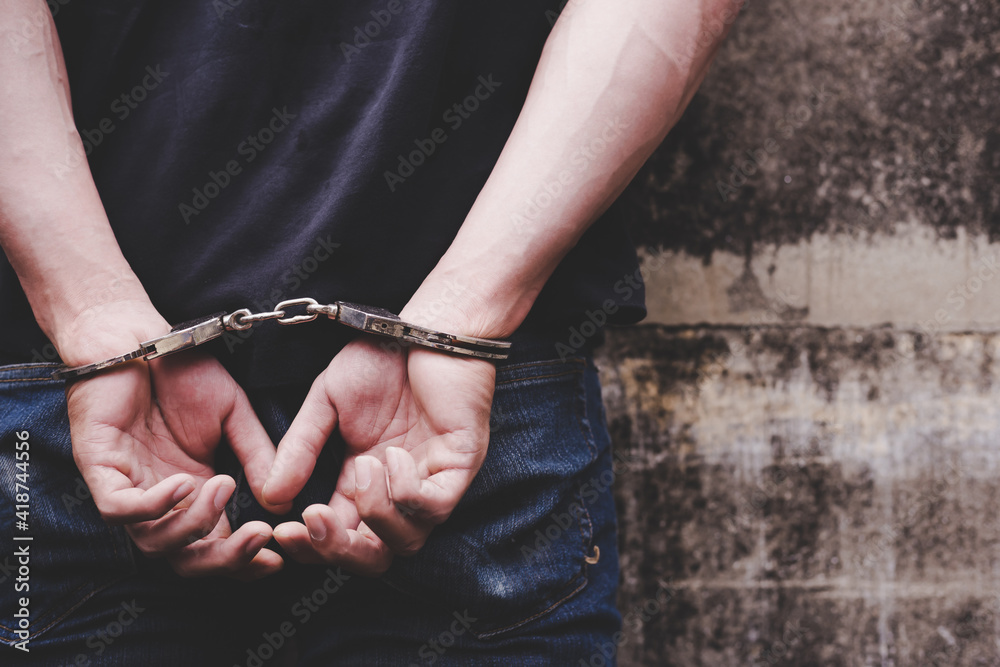 Thief under arrest and get cuffed by policeman Bad person stand against ...