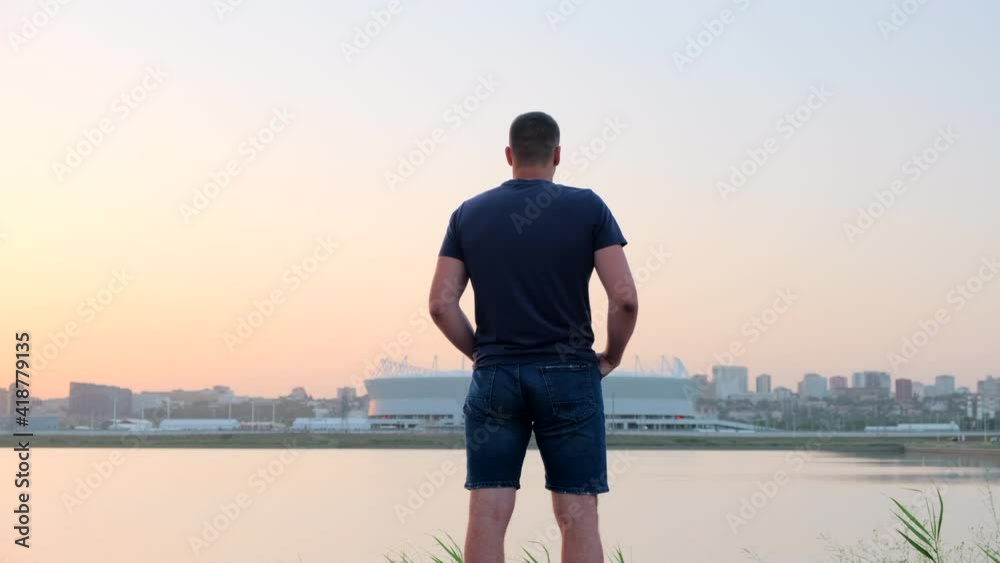 Back view of lonely caucasian man standing and enjoying view looking at ...