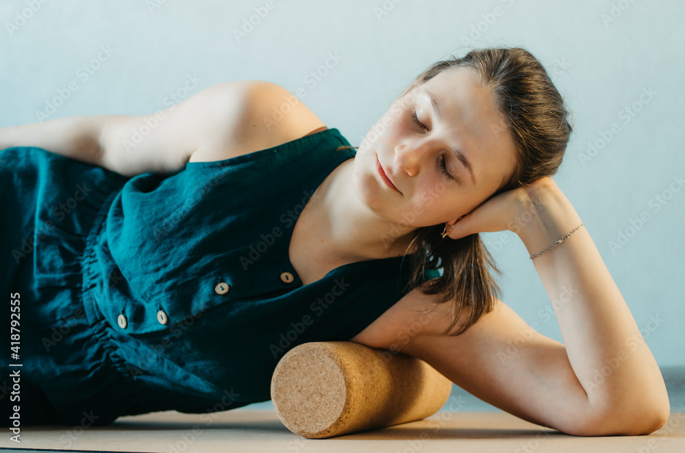 Upper body details of woman rolling lower armpit on a cork massage ...