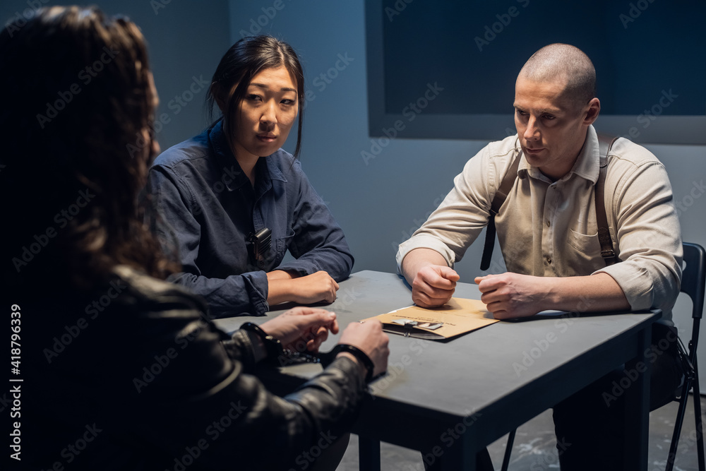 The investigator conducts an interrogation, shows the suspect photos of ...