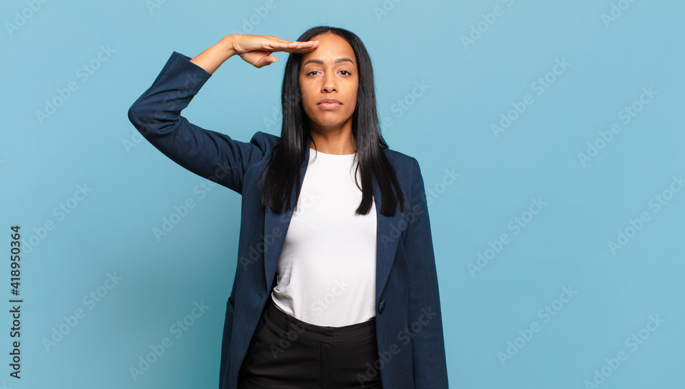 young black woman greeting the camera with a military salute in an act ...