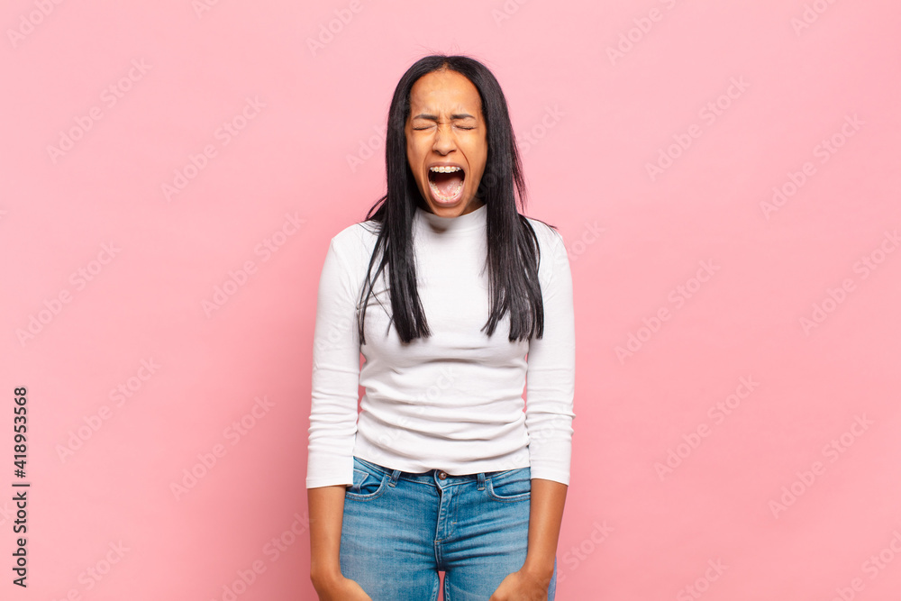 young black woman shouting aggressively, looking very angry, frustrated ...