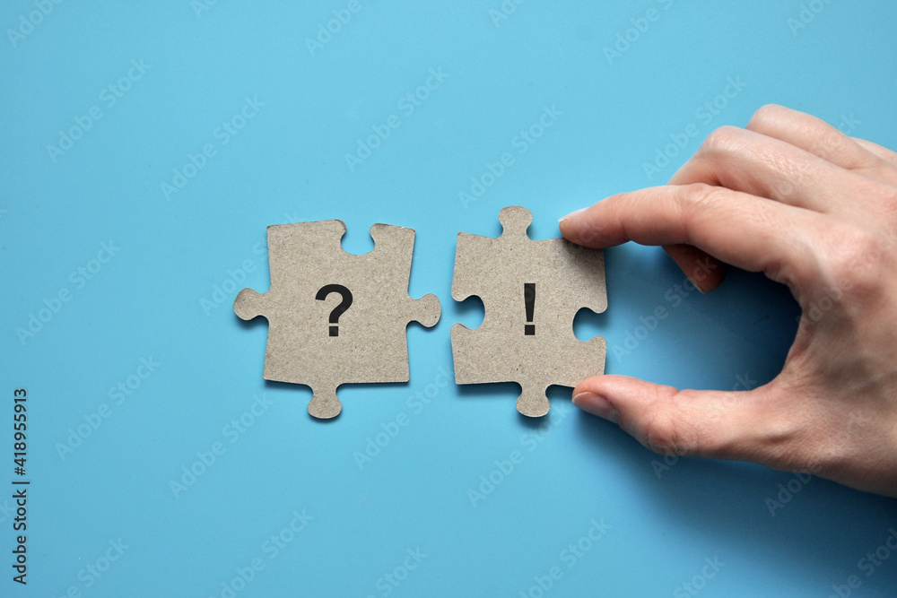 Puzzle pieces with question and exclamation mark icons. The symbol of ...