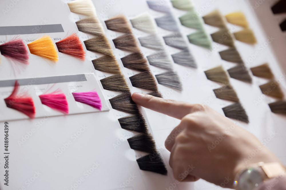 Woman Choosing Color from the Hair Color Chart For Hair Dye Concept ...