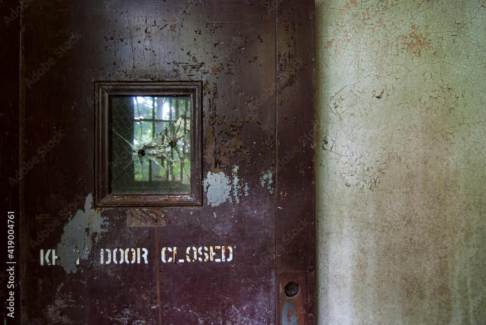 Broken door inside an abandoned mental asylum Stock Photo | Adobe Stock