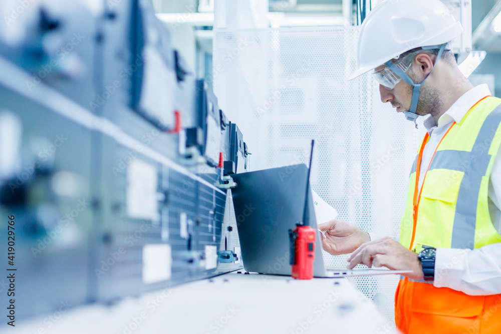 Admin maintenance engineers inspect relay protection system with laptop ...