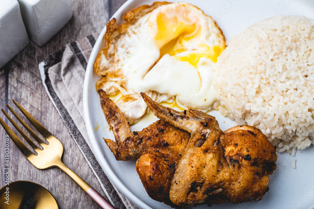 Chicksilog (close up wings) -is a famous Filipino meal that consists of fried rice, egg and ...