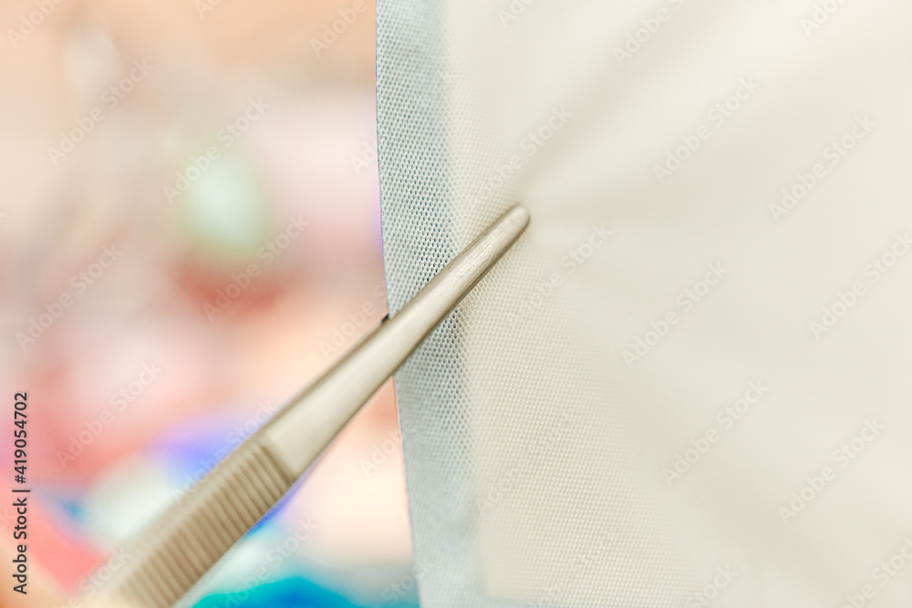 Close-up of a compress holding with forceps. Action step of nurse ...