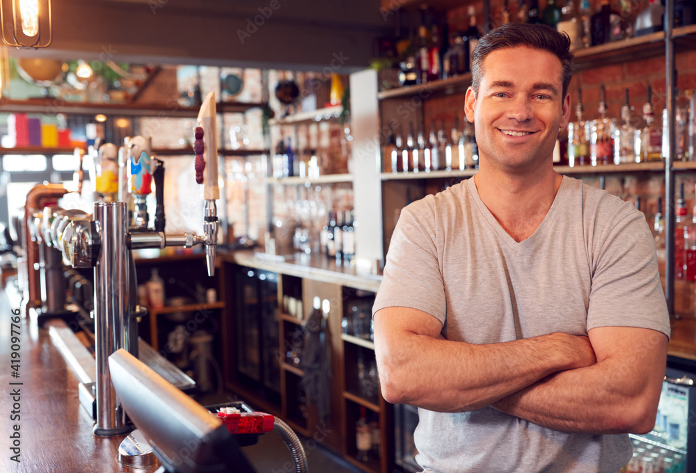 Portrait Of Smiling Male Bar Owner Standing Behind Counter Stock Photo ...