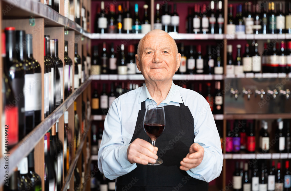 Successful glad cheerful positive elderly male owner of winery inviting ...