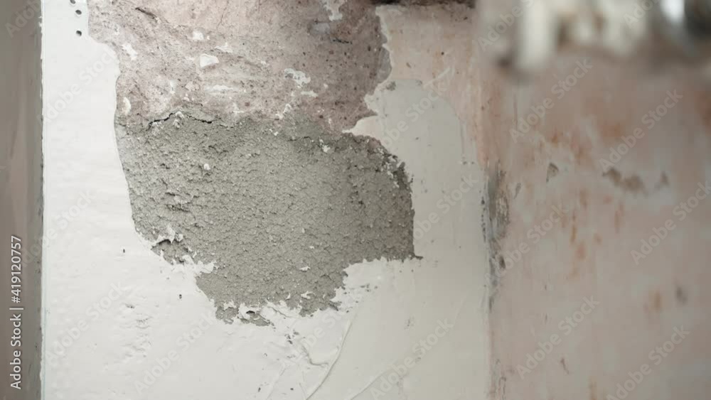 Close-up of unfinished cement wall on construction site, plasterer ...