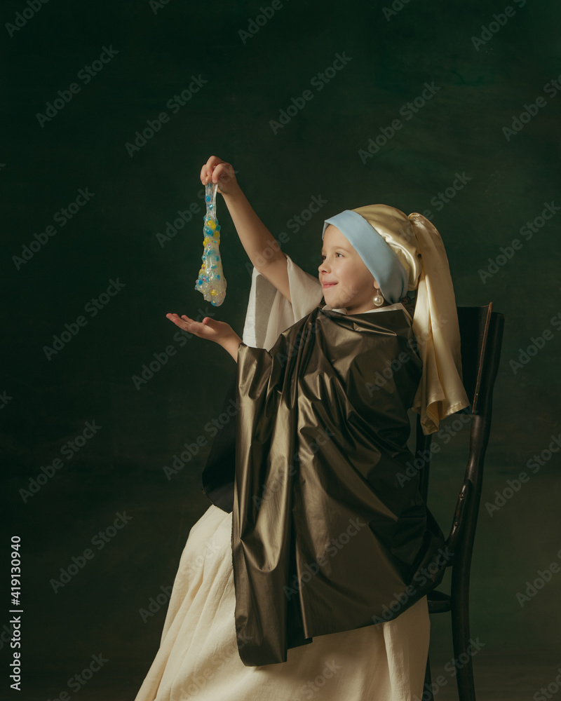 Slime. Medieval little girl as lady with a pearl earring on dark studio ...