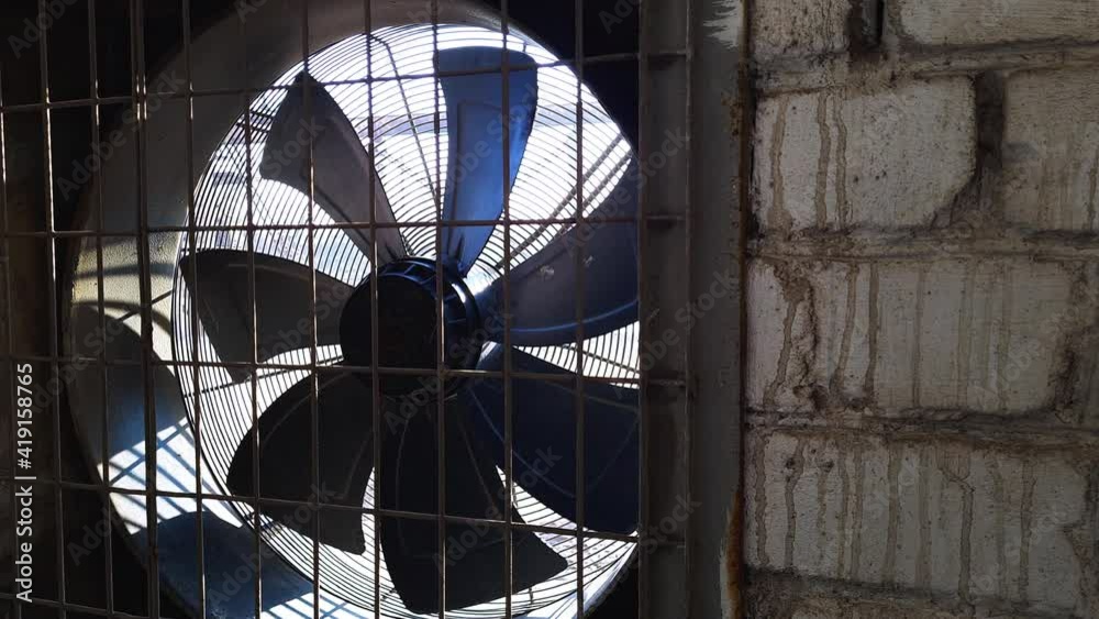 Vidéo Stock Big industrial fan in a white brick wall of a plant ...