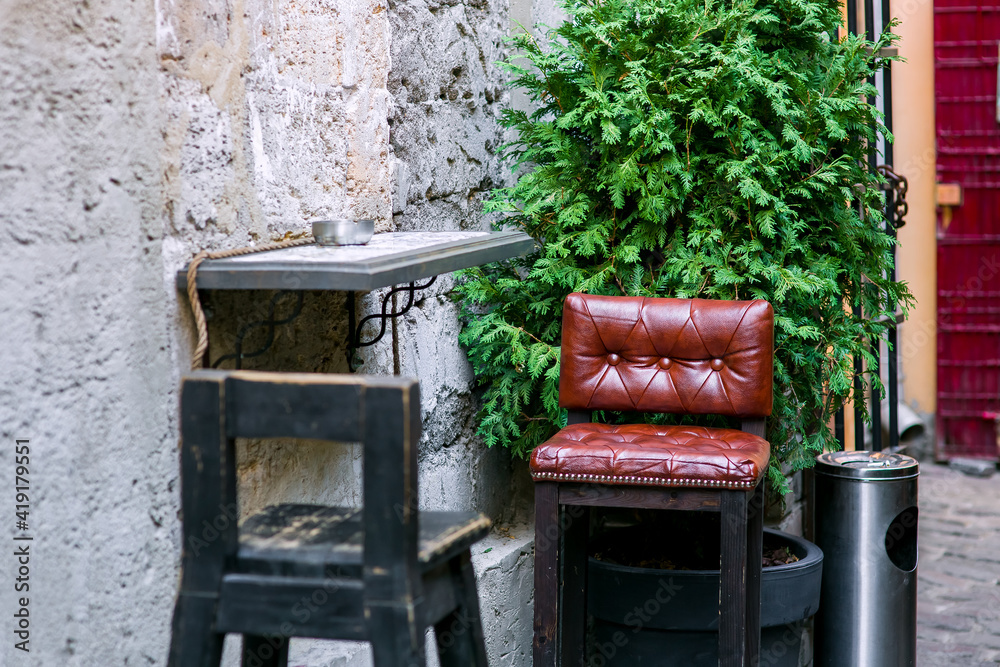 bar stool with high legs against the wall with a table, smoking area ...