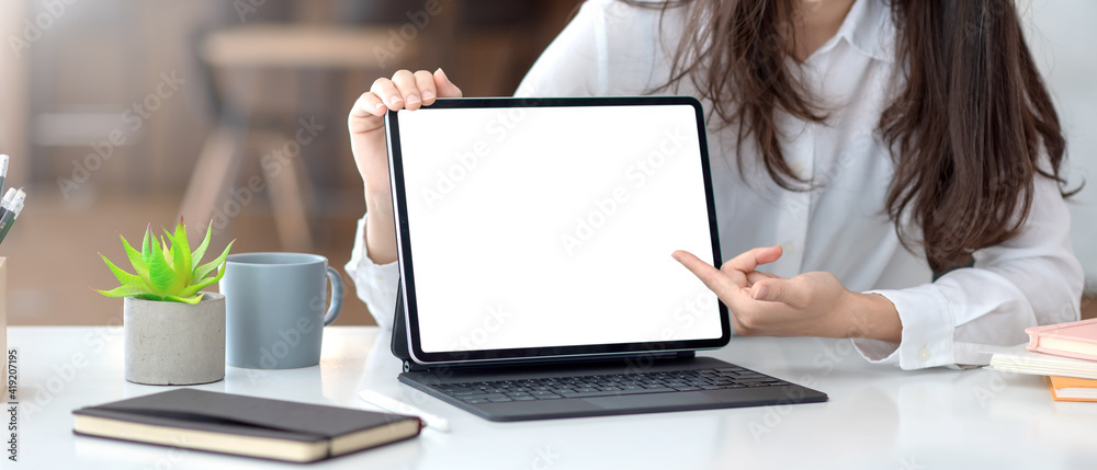 Businesswoman working a using tablet blank white screen at the office ...