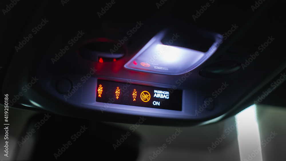 Passenger airbag status warning light on display of a car console ...
