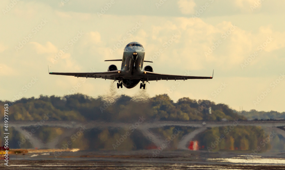 A passenger Airplane is taking off from the runway of an airport at ...