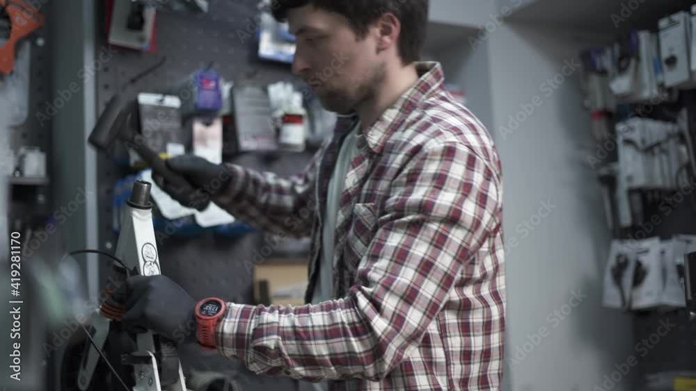 Electric scooter repair workshop. Mechanic holds in his hand broken ...