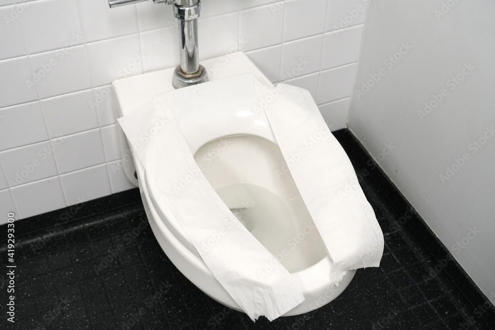 open toilet seat with toilet paper cover Stock Photo | Adobe Stock