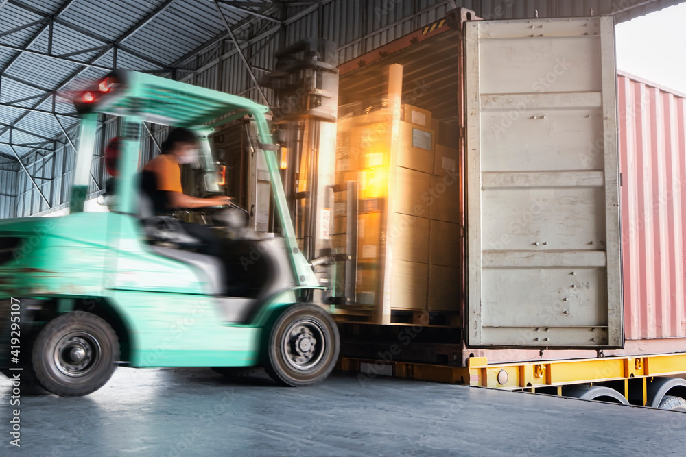 Forklift Tractor Loading Cargo Boxes at Dock Warehouse. Shipment ...