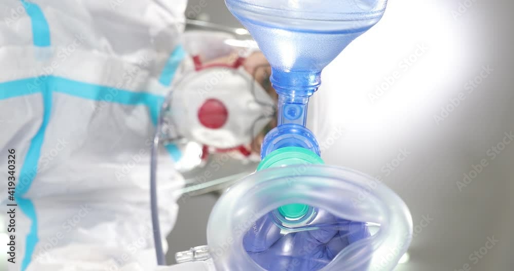 Team of Doctors wearing coverall Face Masks Doctors putting an oxygen ...