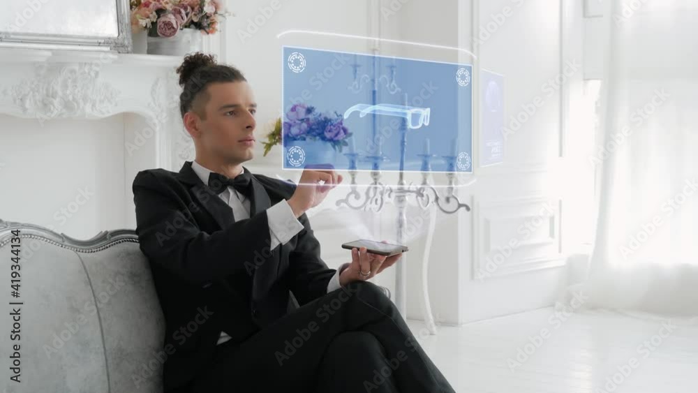 Guy businessman activates conceptual HUD hologram on smartphone with ...