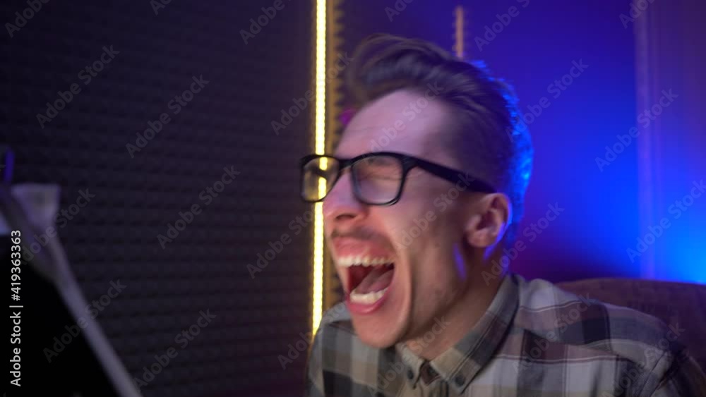 The man laughs. The young guy laughs emotionally. A man sits at a ...