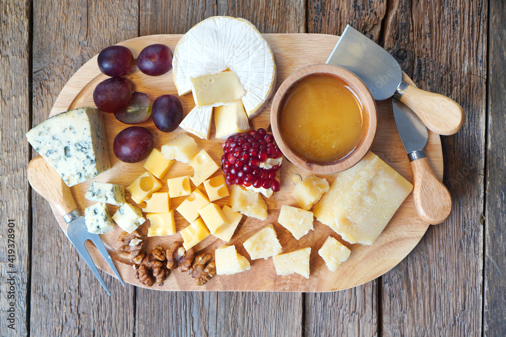 Cheese board with camembert cheese, parmesan cheese, maasdam cheese ...