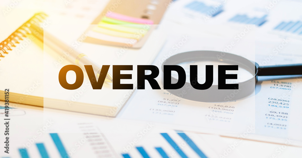Arrears in financial chart with magnifying glass and notepad on table ...