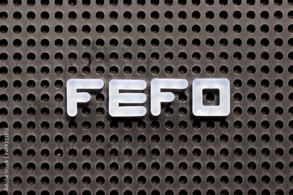 White color letter in word FEFO (first expired first out) on black ...
