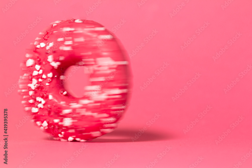 Donut in speed motion isolated on colored studio background. Round cake ...