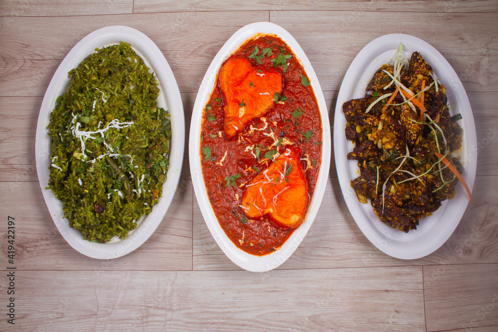 Various Indian food on a dark wooden background. Indian dishes. Curry ...