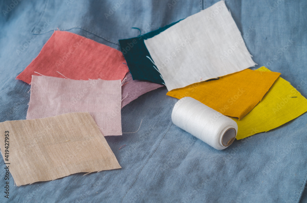 Close up of colour swatches samples of organic linen fabric and sewing ...