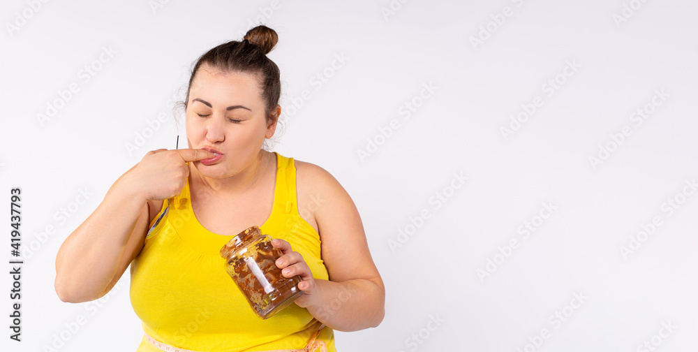 Banner,long format. An overweight woman happily eats chocolate paste ...