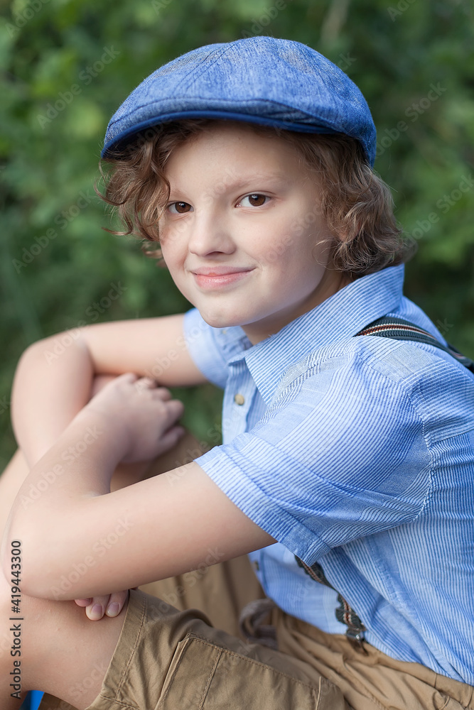 Young boy posing in summer park with palm trees. Cute spectacled ...