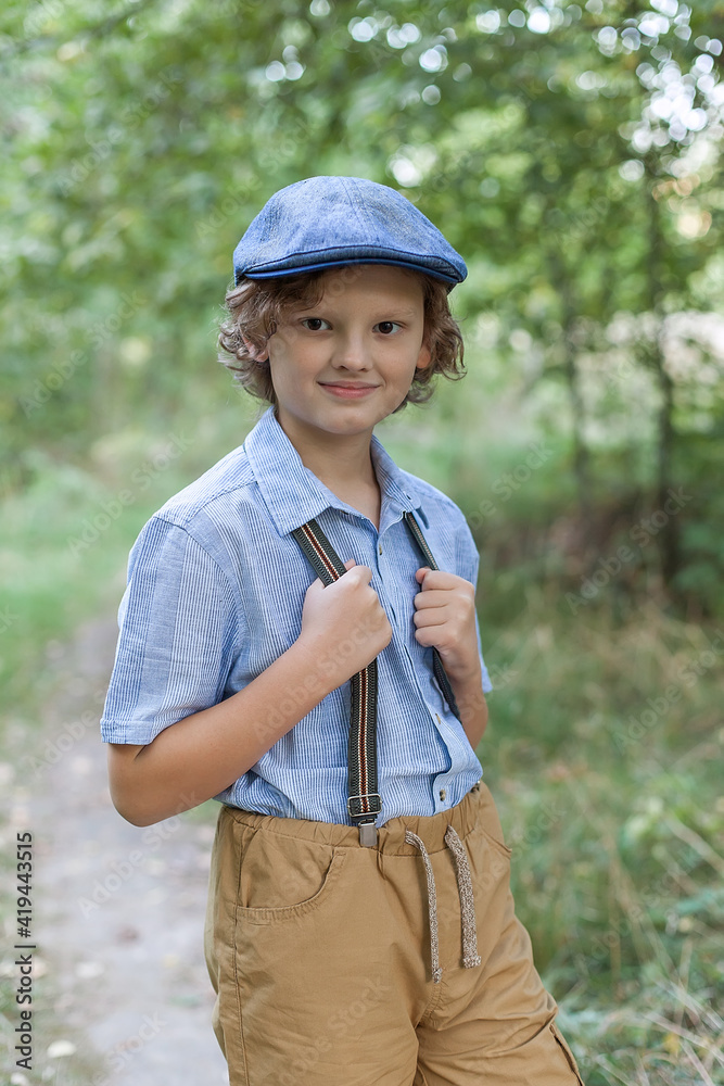 Young boy posing in summer park with palm trees. Cute spectacled ...