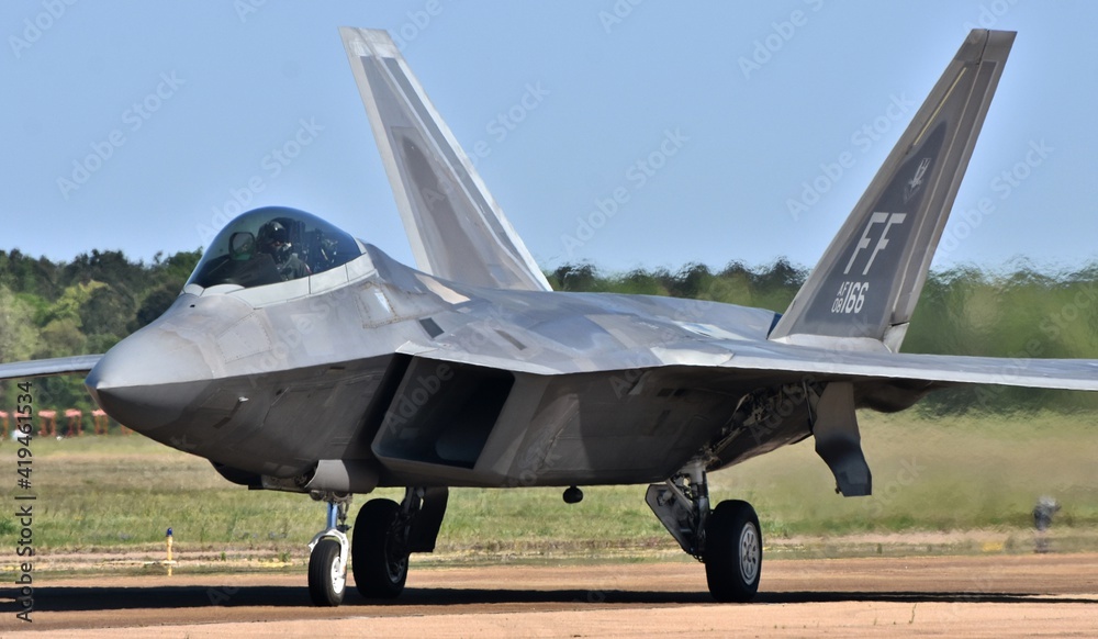 An Air Force F-22 Raptor fighter jet taxiing on a runway. Stock Photo ...