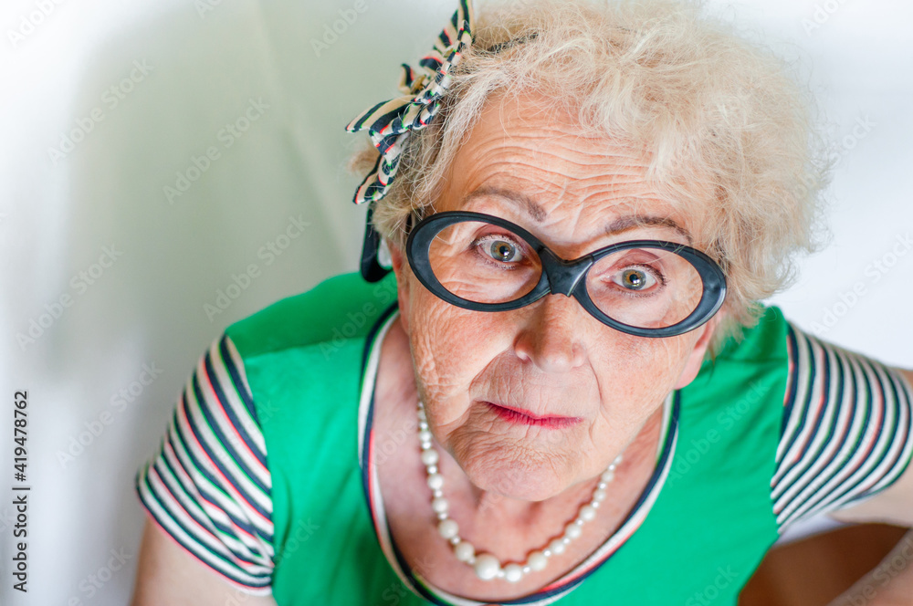 Elderly stylish woman with a angry surprised expression on her face top ...
